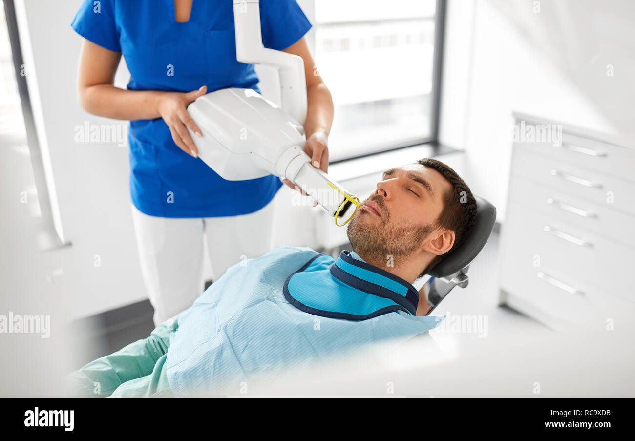 dentist making dental x-ray of patient teeth Stock Photo - Alamy