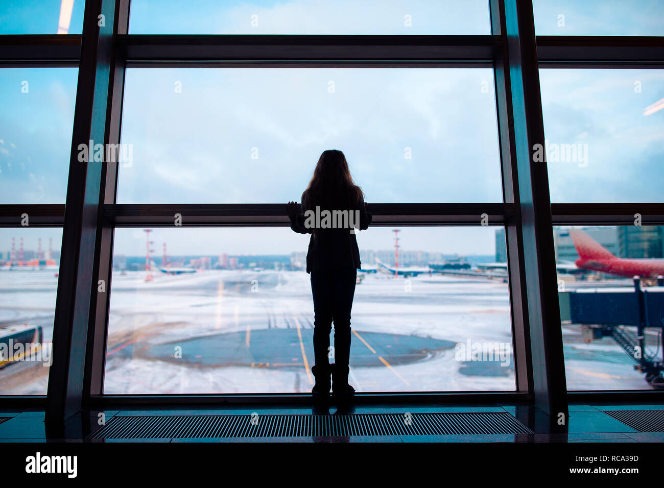 Little girl in airport near big window while wait for boarding Stock ...
