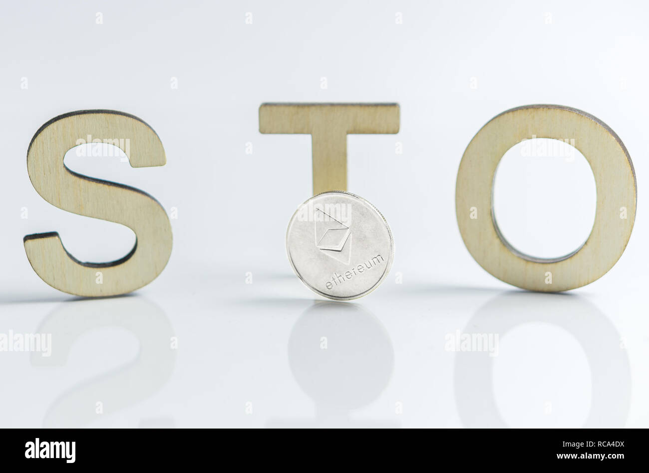 Security Token Offering STO sign with wooden letters and silver ...