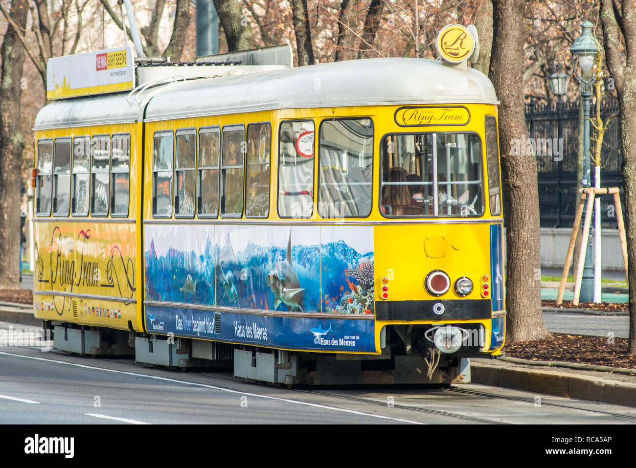 Nostalgic traditional yellow "Vienna Ring Tram", a tourist tram line at ...