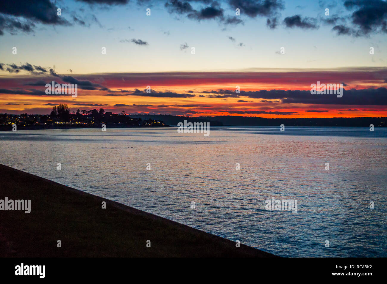 The sky is rich with colors as the sun set at Alki Beach in West ...