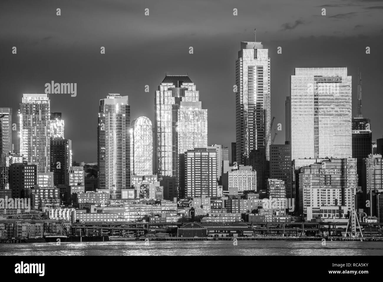 The setting sun is reflected from the skyscrapers in the Seattle ...