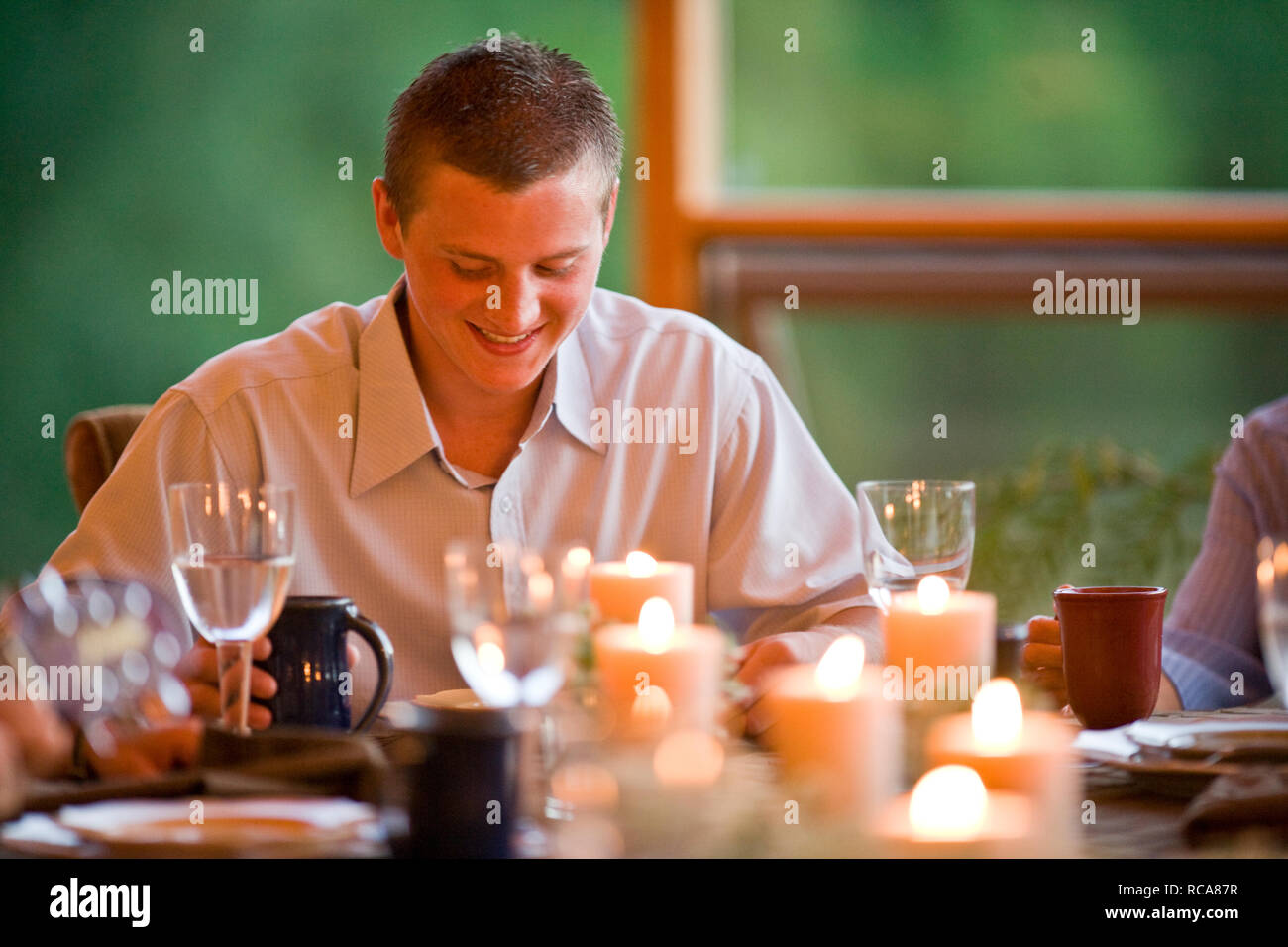 Teenage boy sitting at dinner table Stock Photo - Alamy