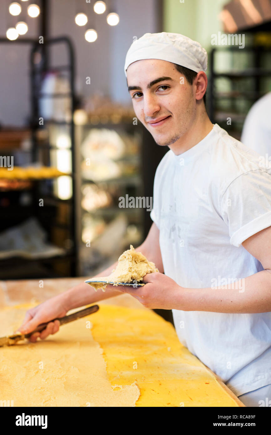 Baker working in bakery Stock Photo - Alamy