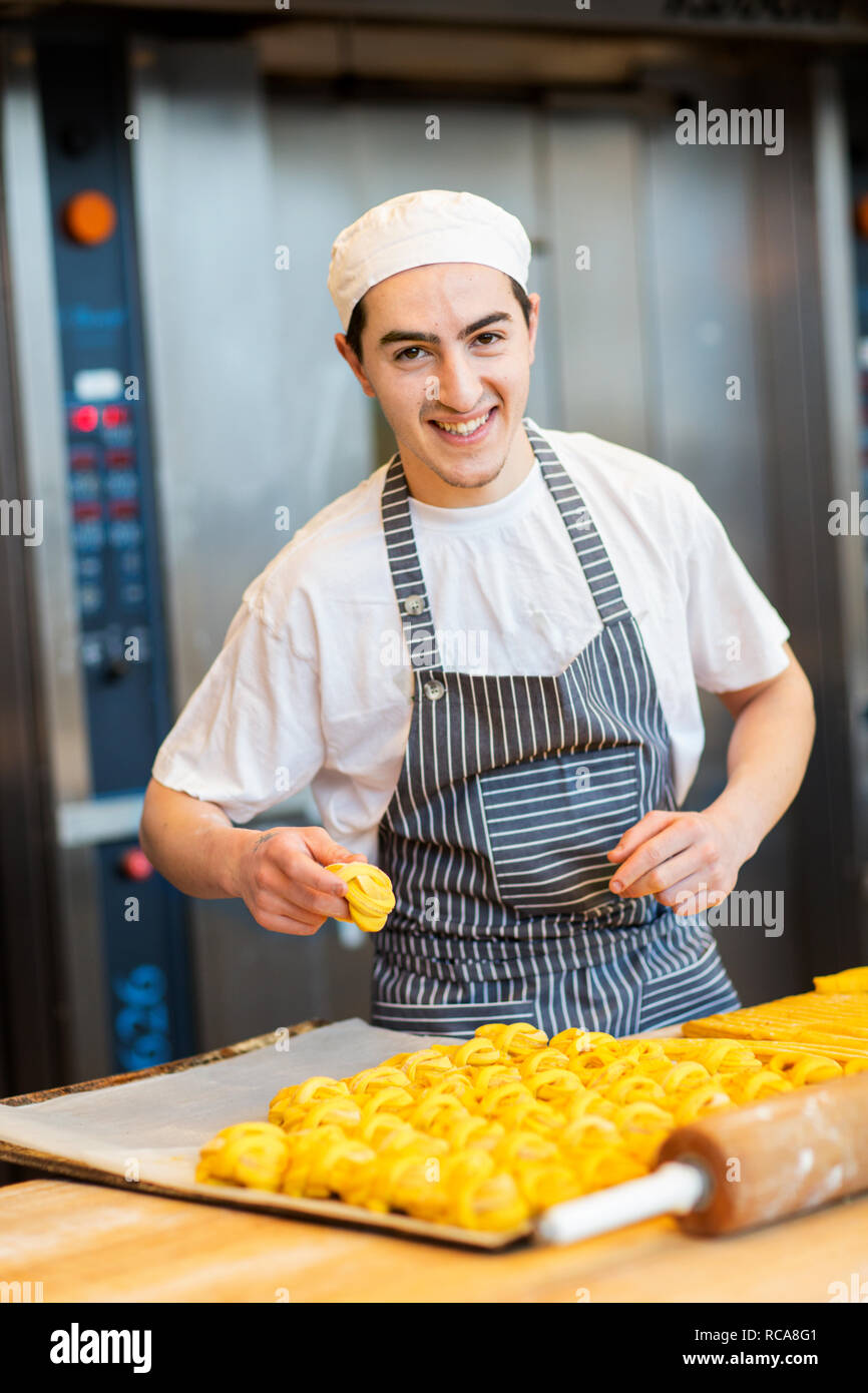 Baker working in bakery Stock Photo - Alamy