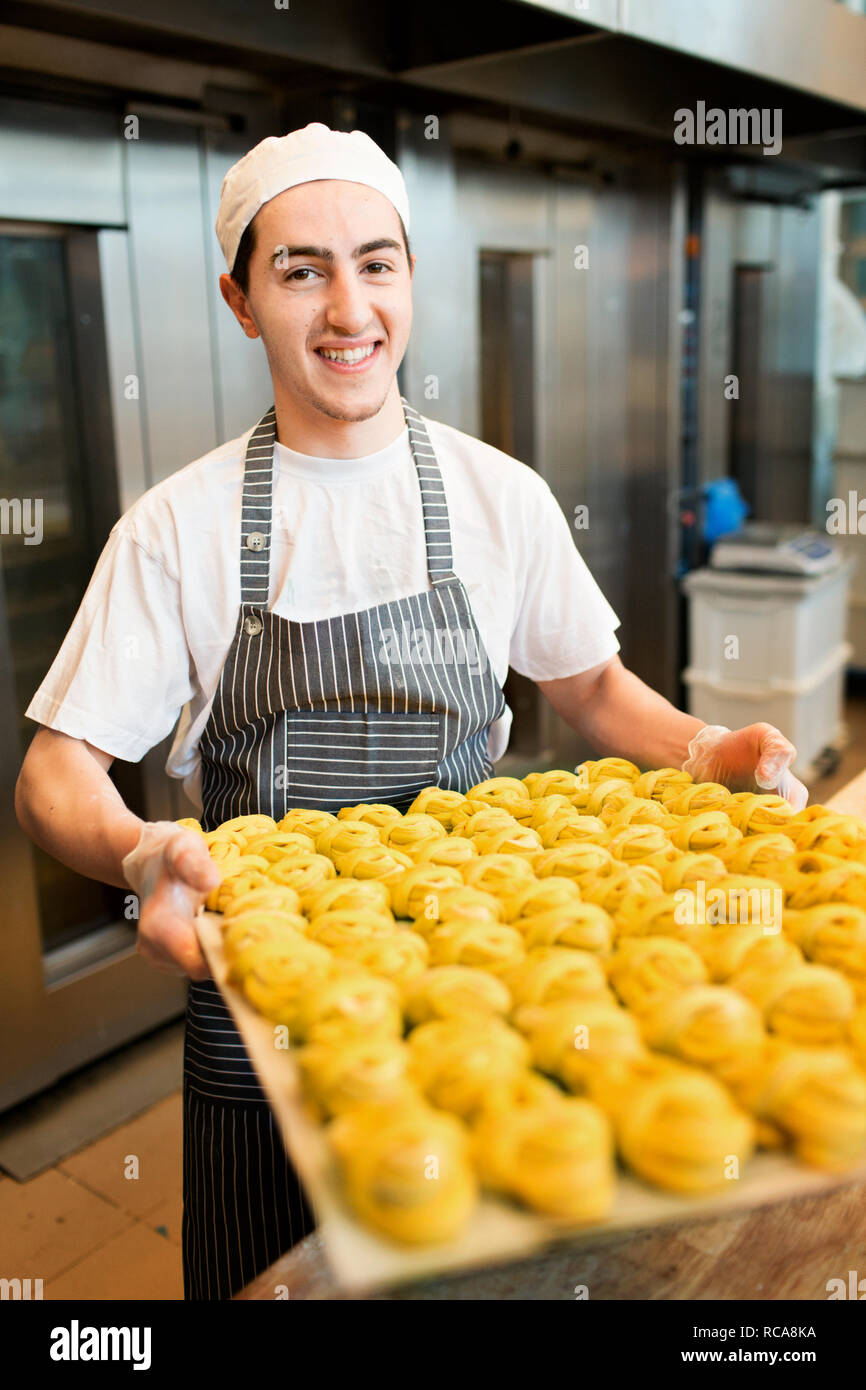 Baker working in bakery Stock Photo - Alamy