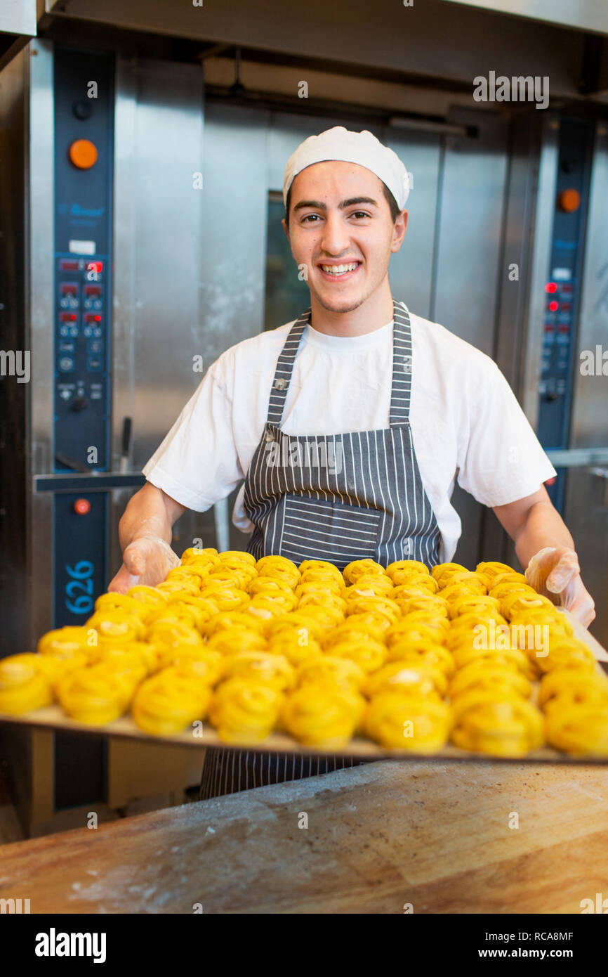 Baker working in bakery Stock Photo - Alamy