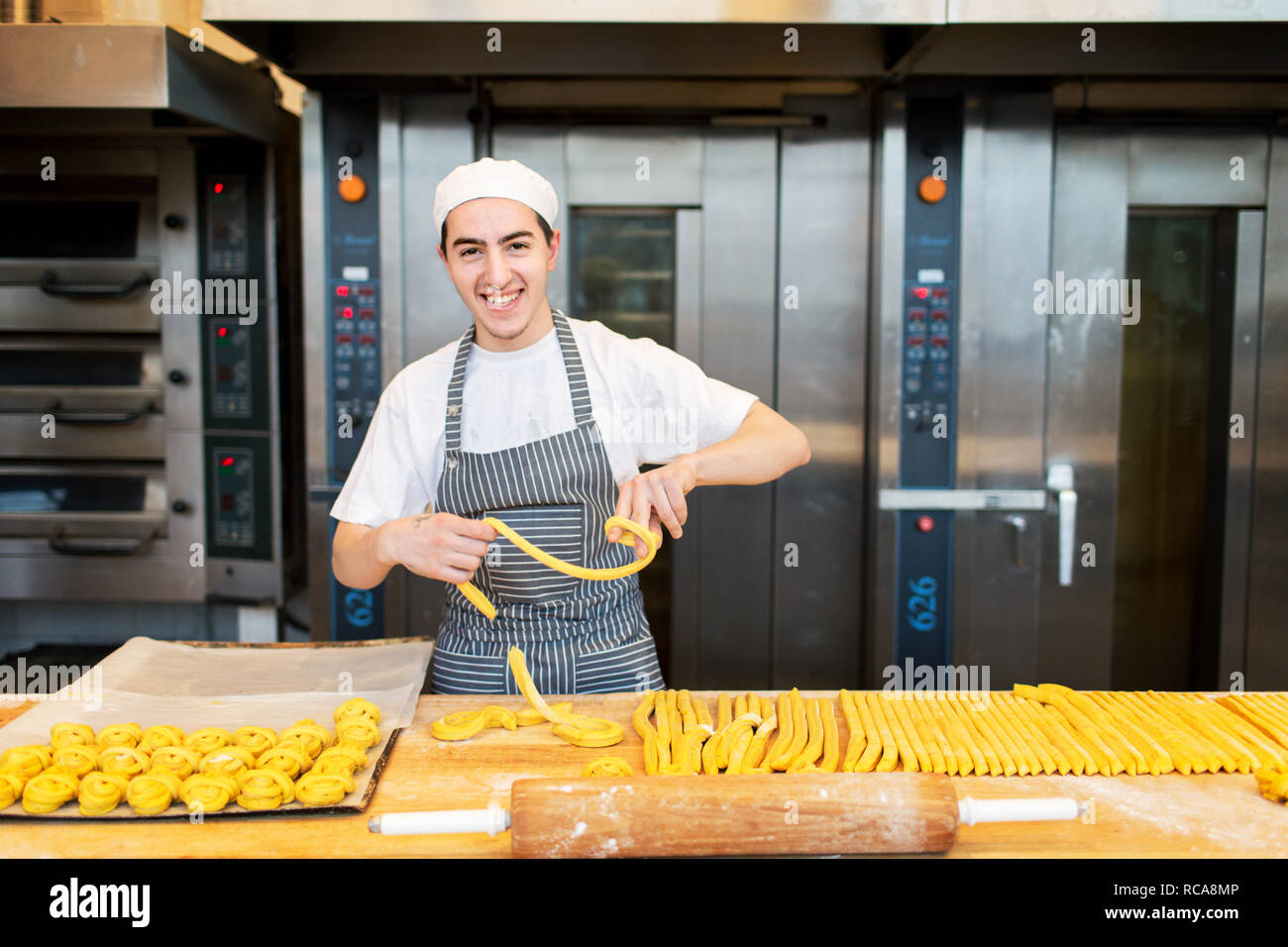 Baker working in bakery Stock Photo - Alamy