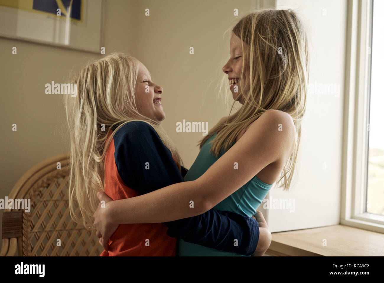 Happy sisters together Stock Photo - Alamy