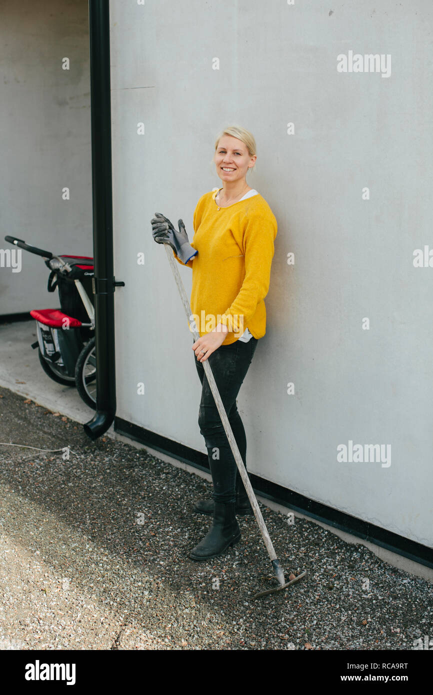 Woman with rake hi-res stock photography and images - Alamy