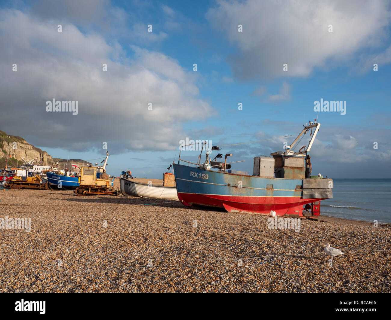 Commercial fishing boats on the shingle beach at Hastings East Sussex ...
