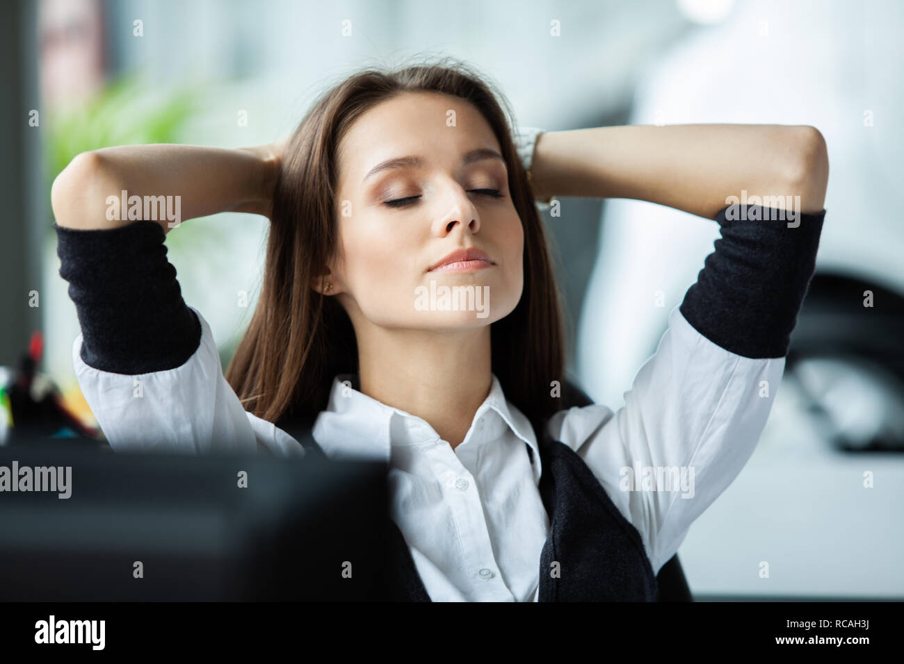 Cheerful businesswoman dreaming at workplace. Female office worker ...