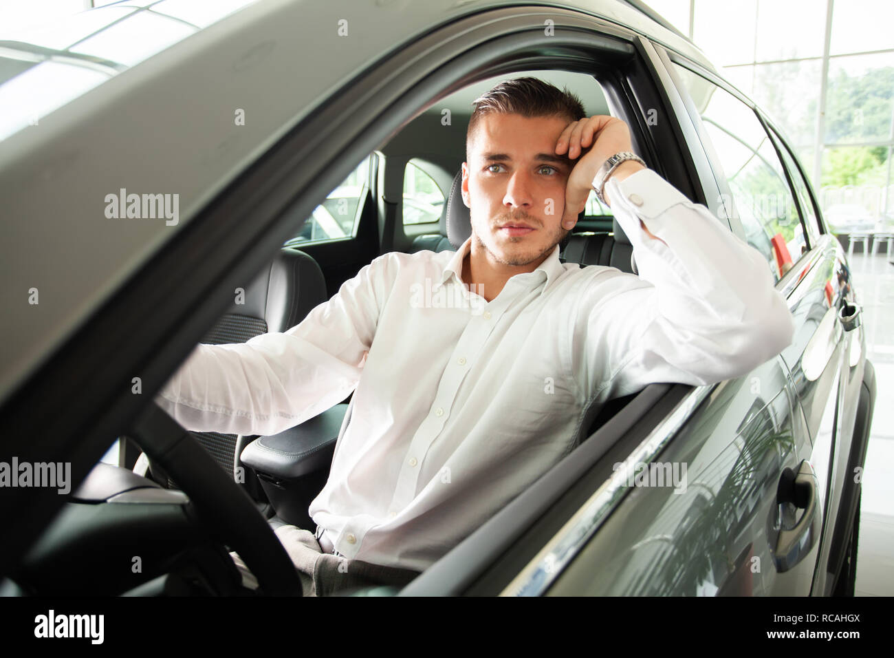 Happy car owner in his new car Stock Photo - Alamy