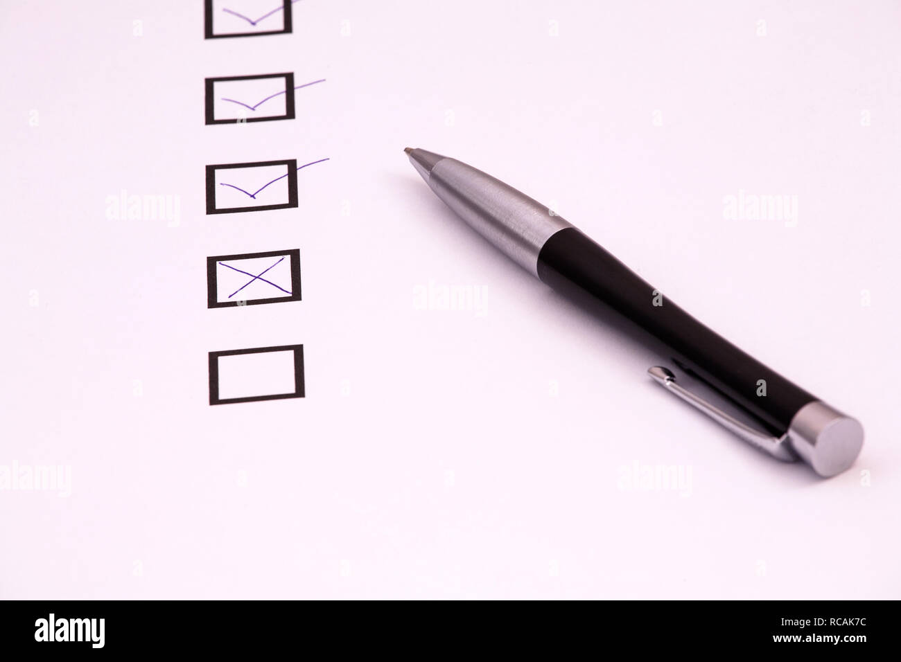 Checklist with a pen Stock Photo - Alamy