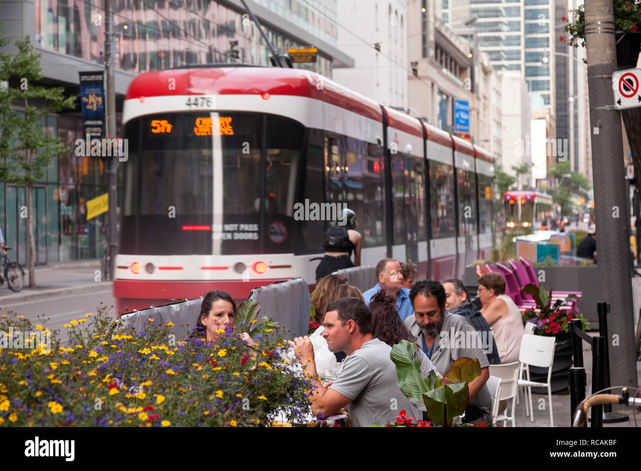 People eating at an outdoor patio along Wellington Street W. City of ...