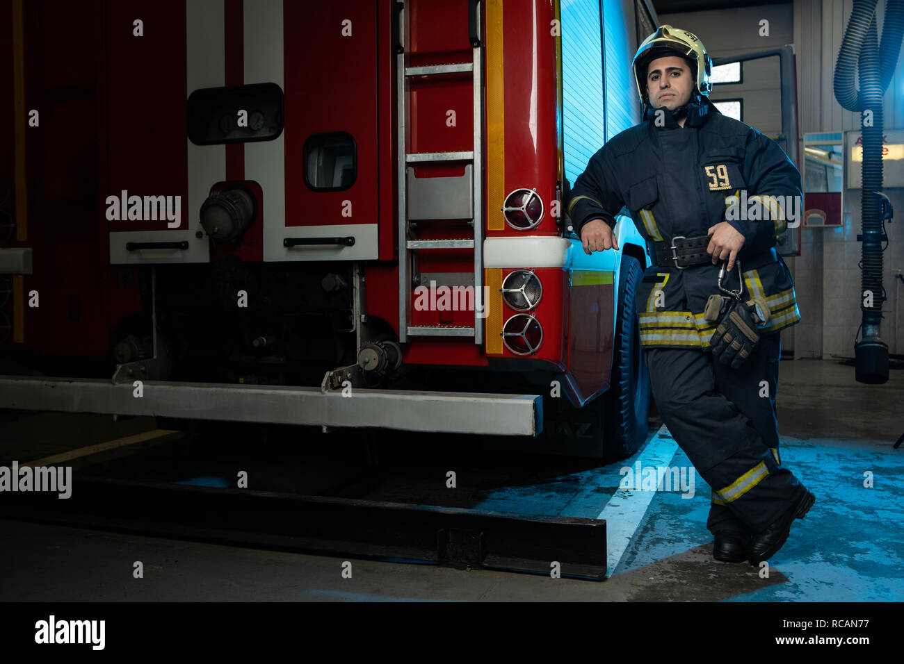 Full-length picture of man firefighter at fire truck Stock Photo - Alamy