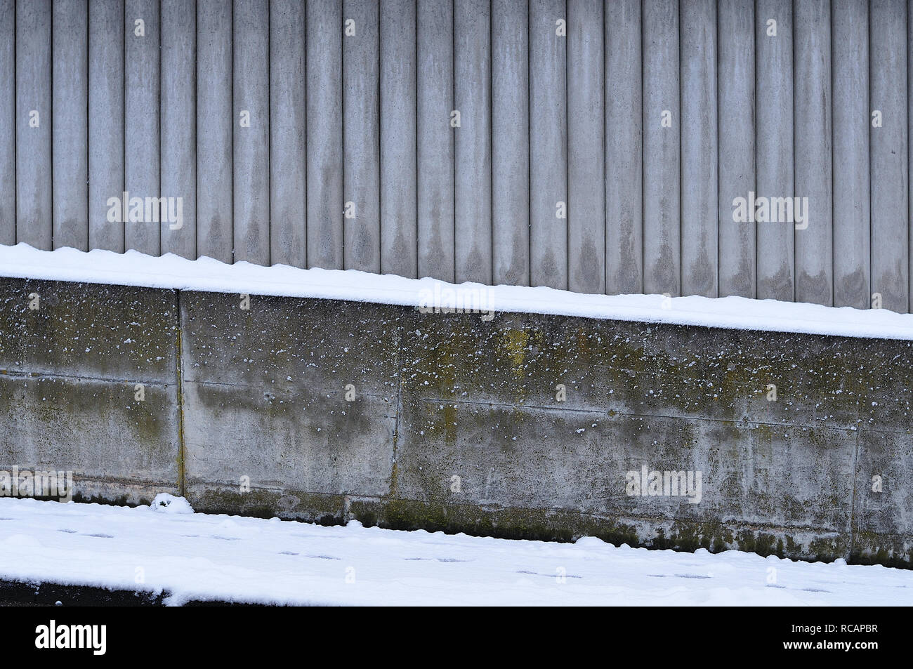 concrete wall alongside snow covered pavement in winter Stock Photo - Alamy