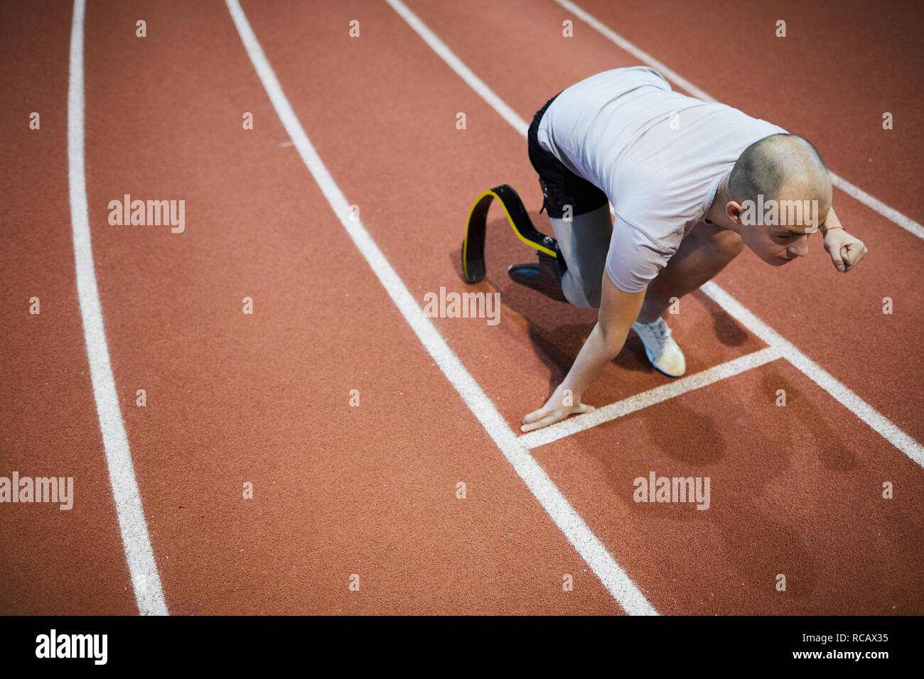 Young man bending forwards hi-res stock photography and images - Alamy