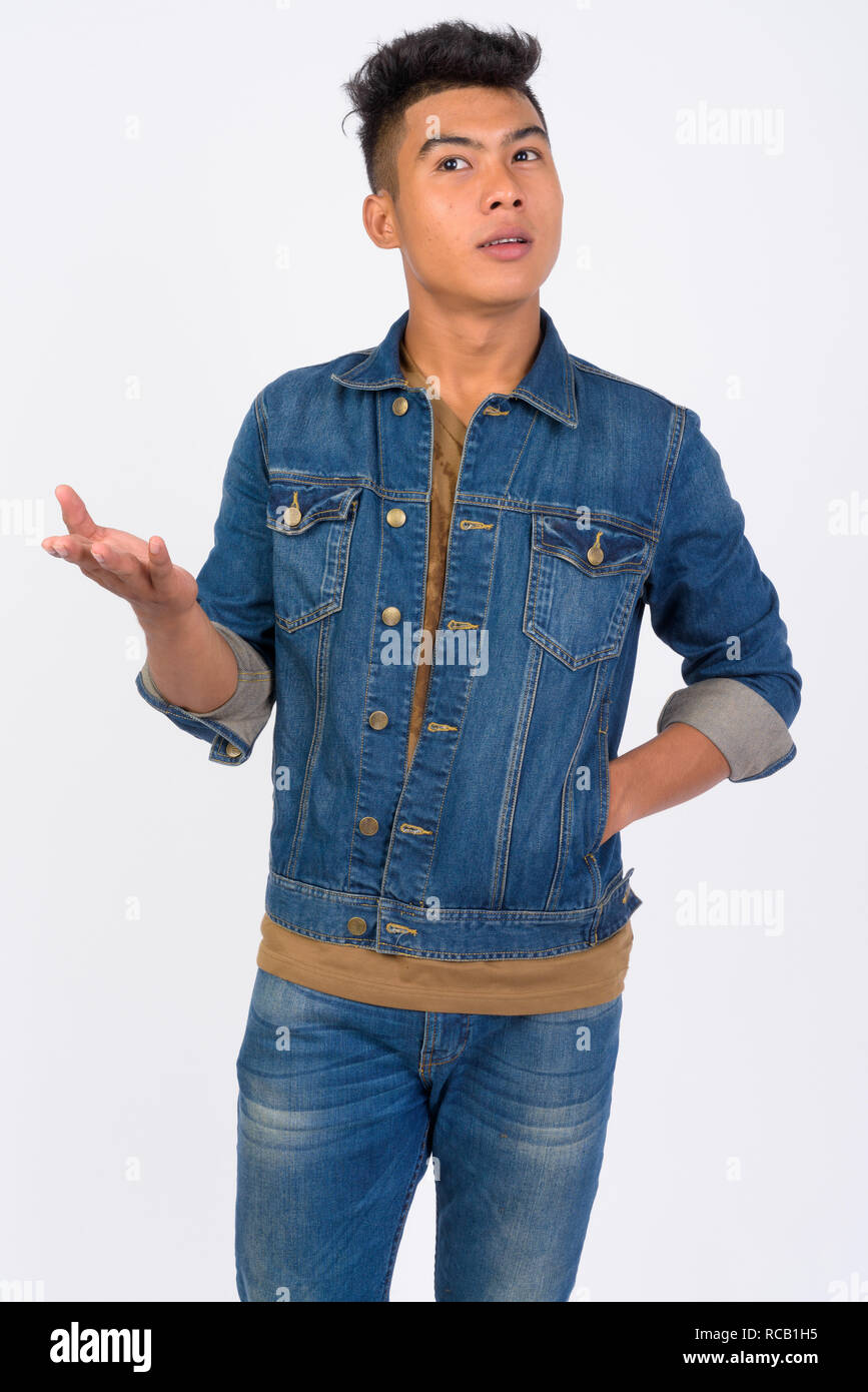 Young Asian man talking and gesturing against white background Stock ...