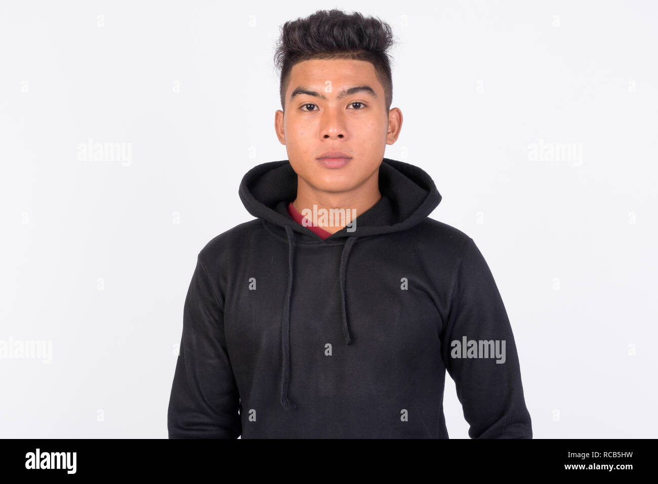 Young Asian man looking at camera against white background Stock Photo ...