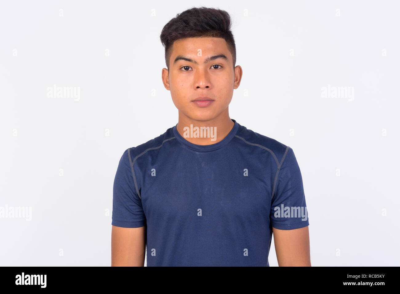Young Asian man looking at camera against white background Stock Photo ...