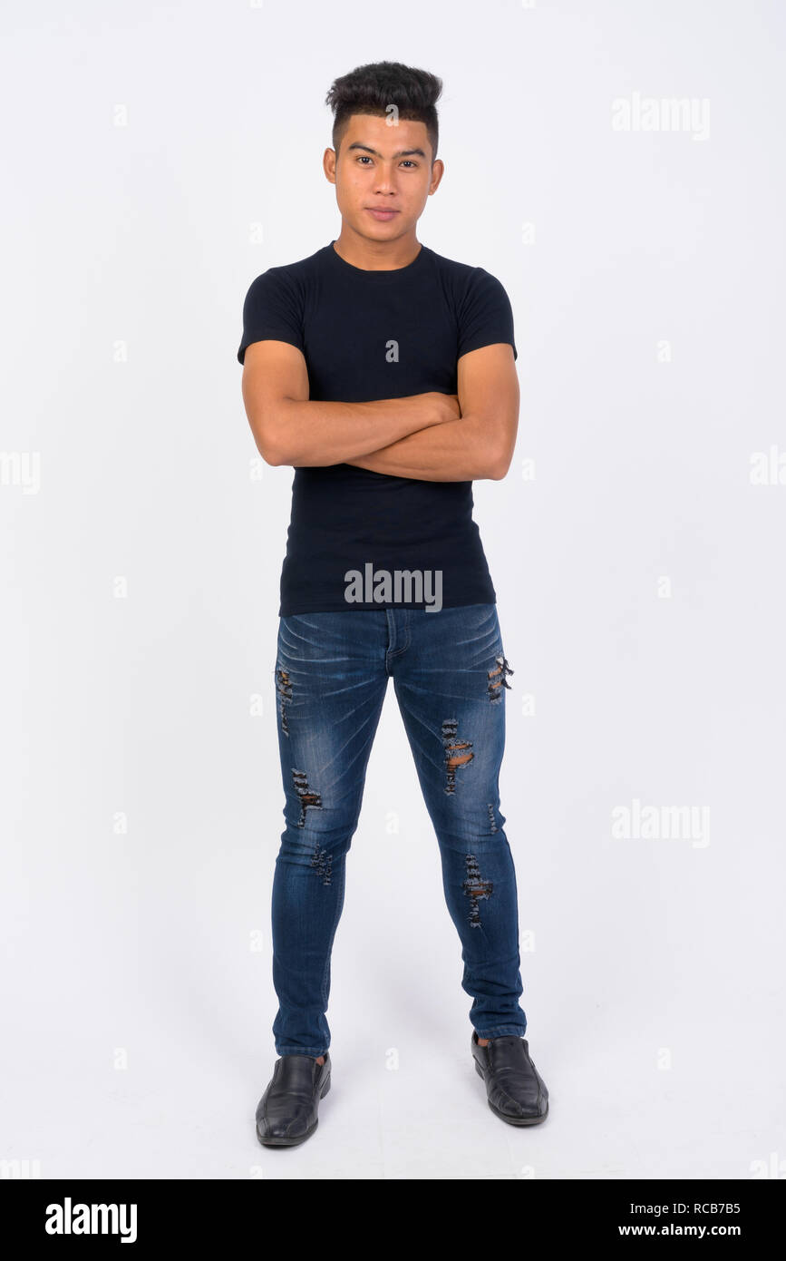 Full body shot of young Asian man against white background Stock Photo ...