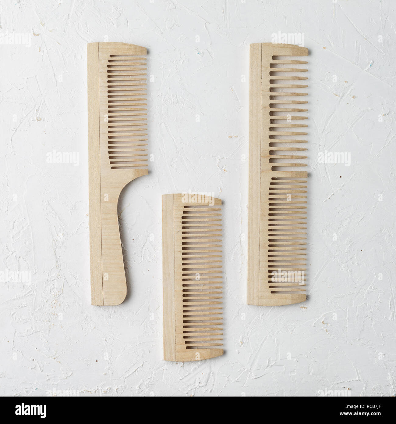 Wooden hair or beard combs flat lay on textured white background Stock ...
