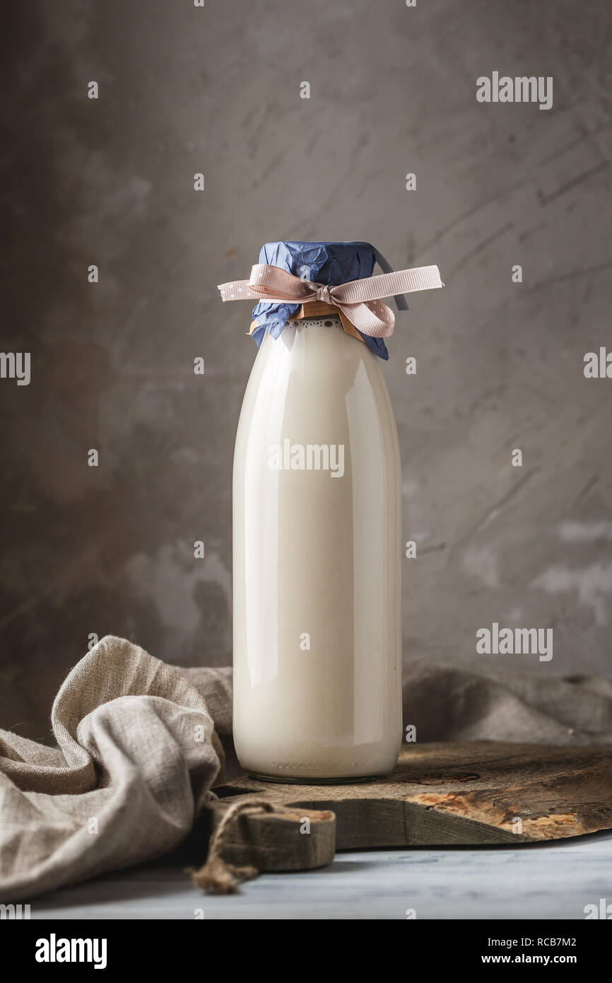Reusable glass bottle of fresh milk on rustic background Stock Photo ...
