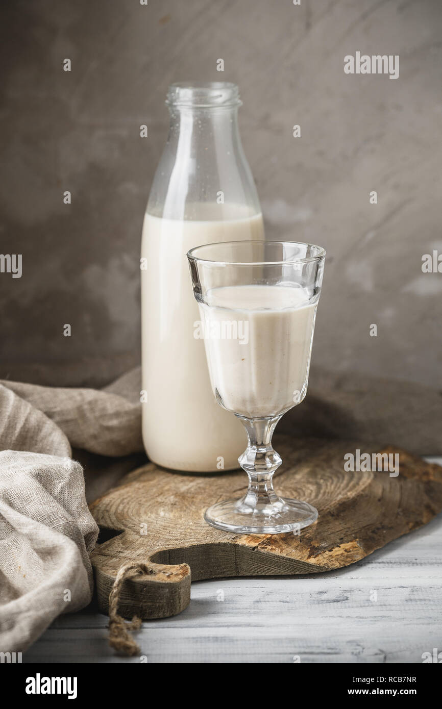 Reusable glass bottle of fresh milk on rustic background Stock Photo ...