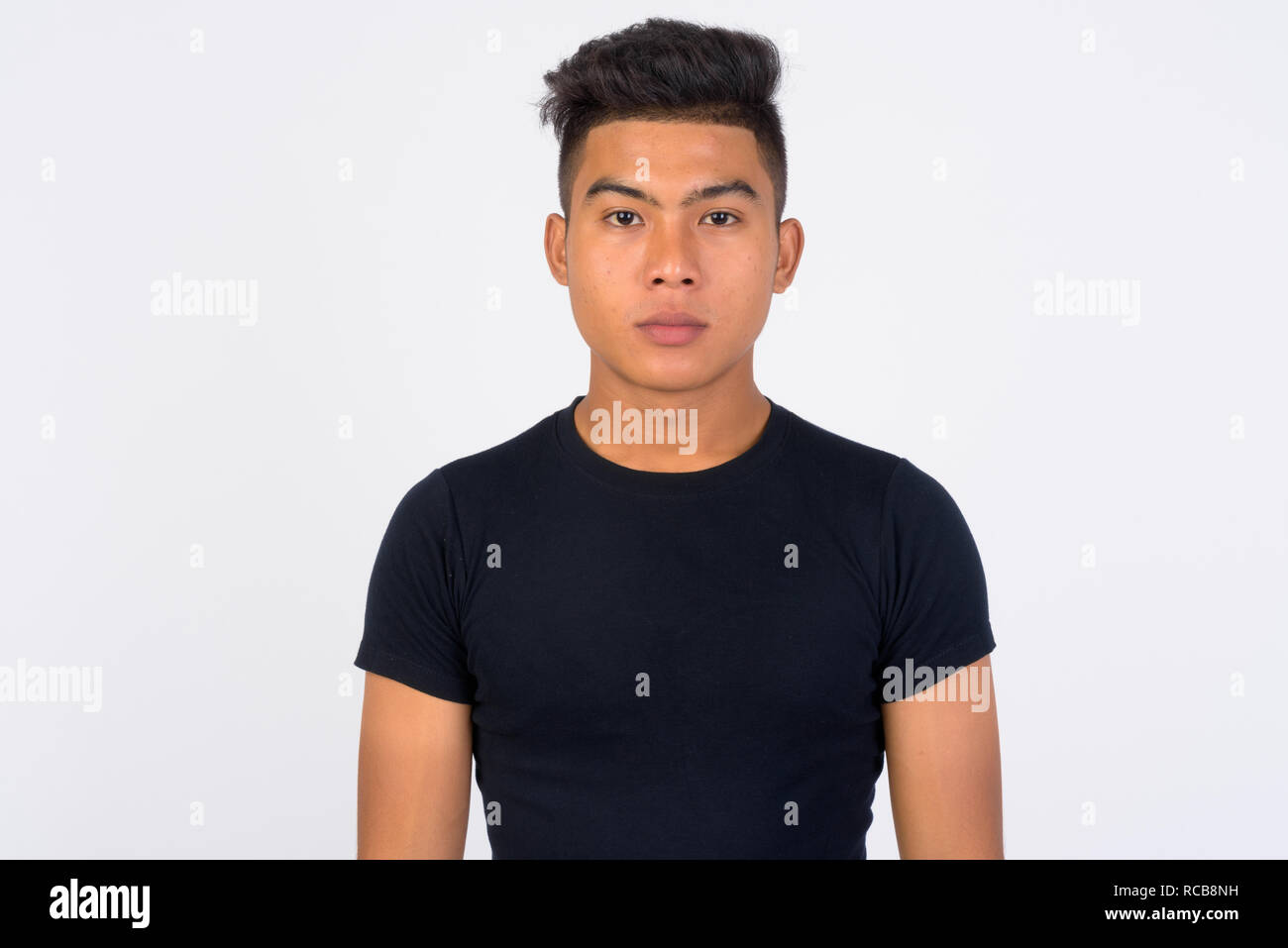 Young Asian man looking at camera against white background Stock Photo ...