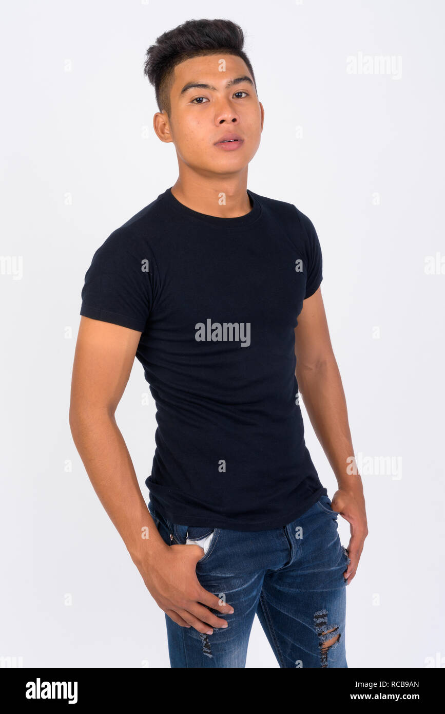 Young Asian man looking at camera against white background Stock Photo ...