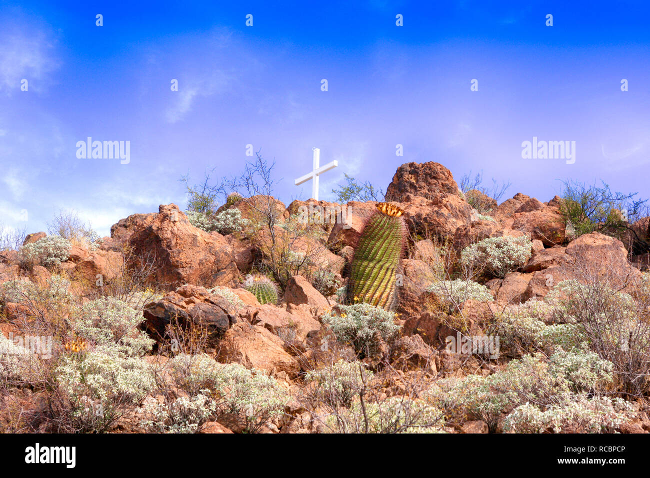 White Christian cross atop a hill close to the San Xavier del Bac ...
