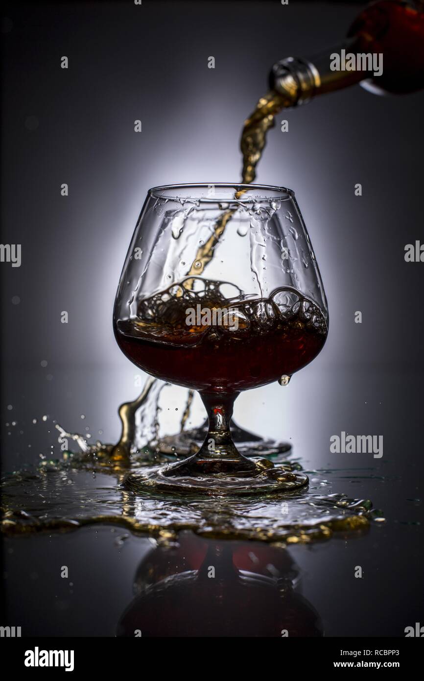 pouring brandy into a glass Stock Photo - Alamy