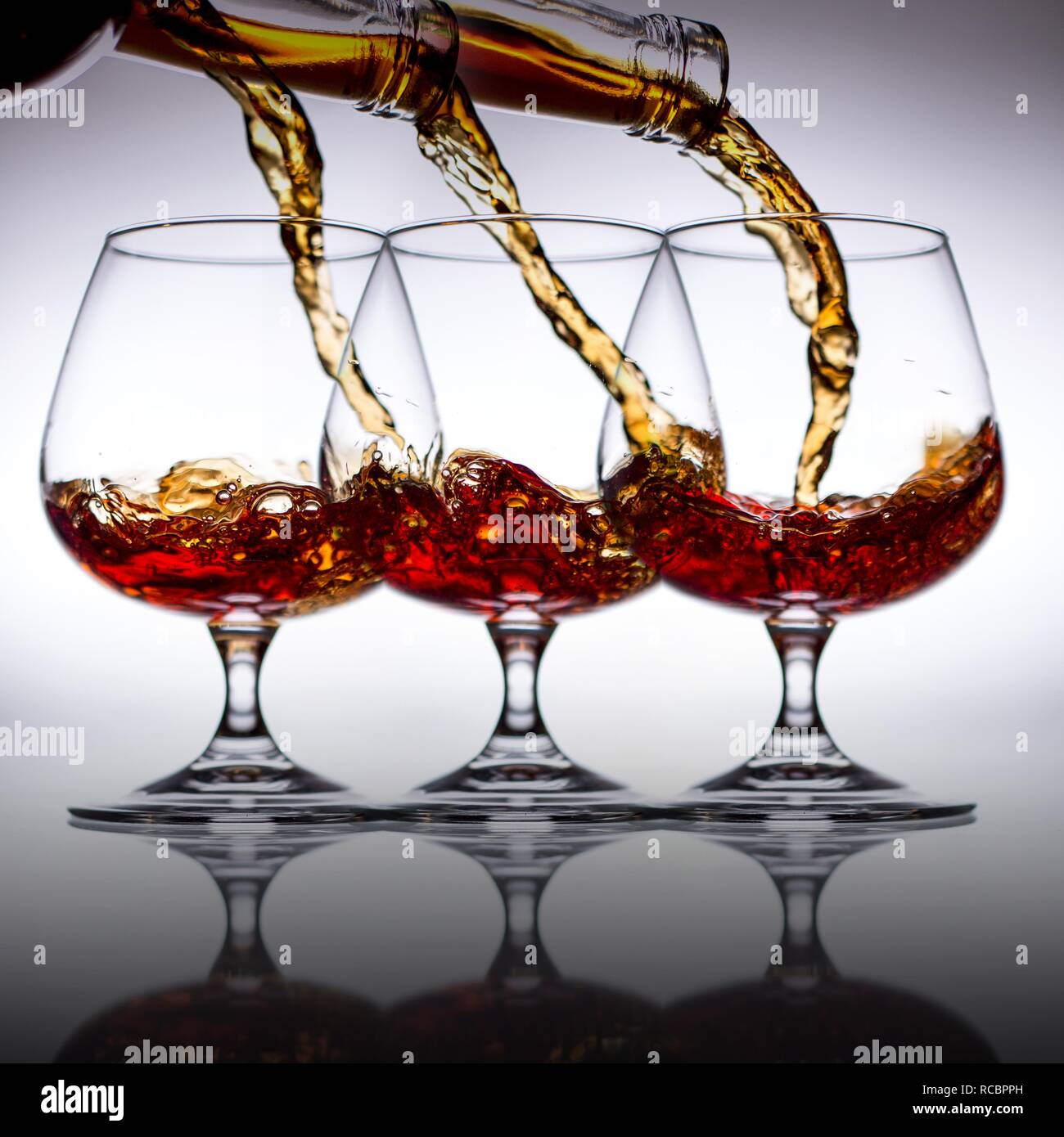 pouring brandy into a glass Stock Photo - Alamy