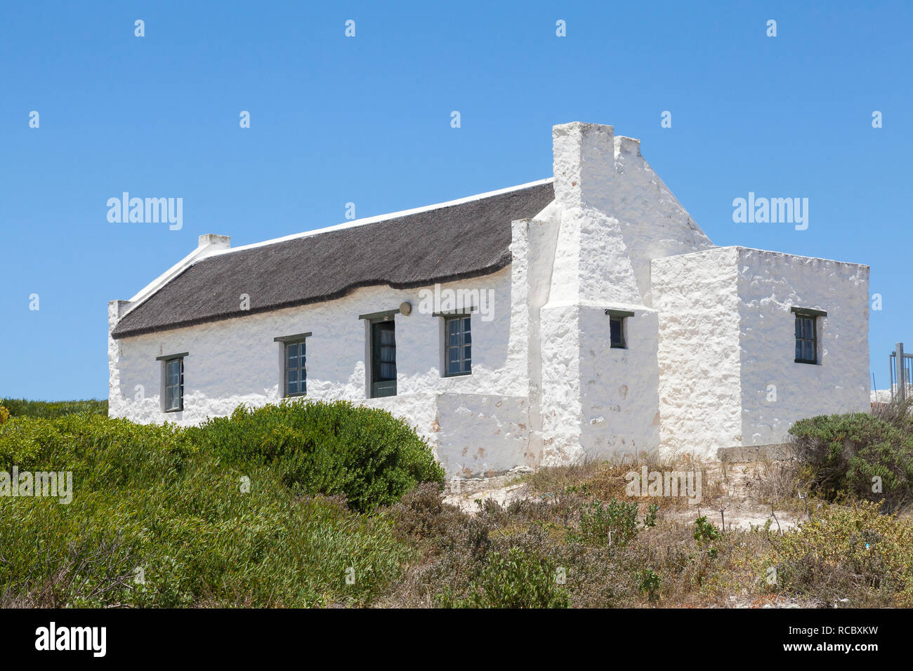 Whitewashed historic cottage in the quaint fishing village of Arniston ...
