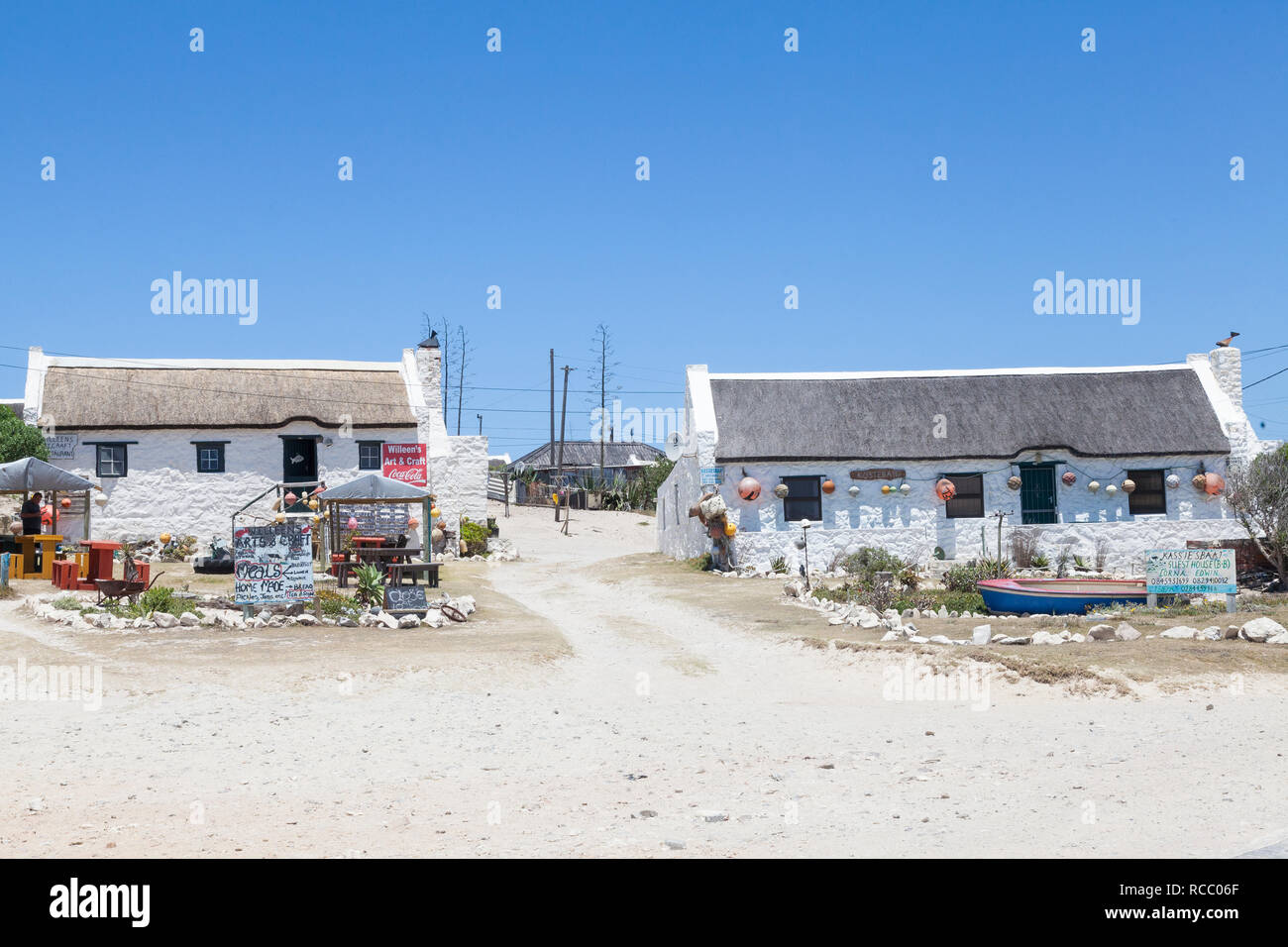 Original Coloured cottages and businesses in the quaint fishing village ...