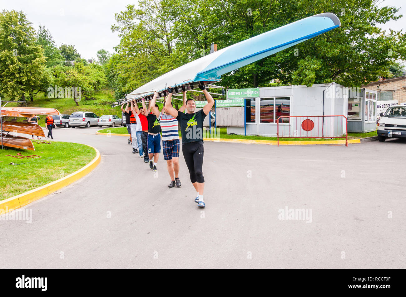 Trakai, Lithuania - July 26, 2013: Eight people carrying an eight that ...