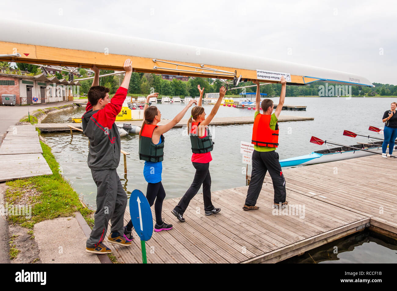 Trakai, Lithuania - July 26, 2013: Tourists carrying an eight that is a ...
