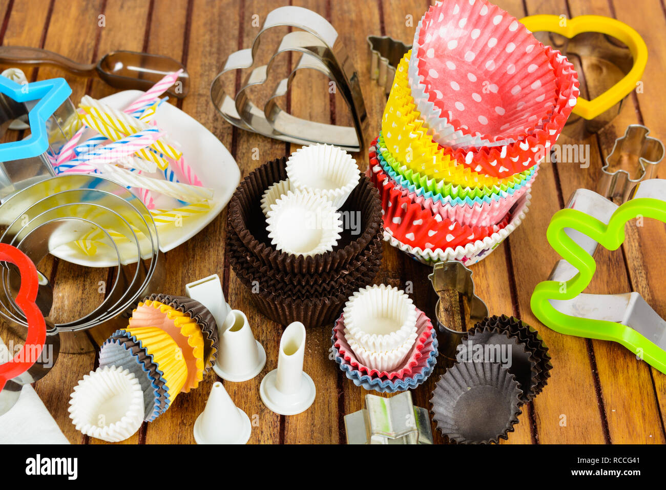 Different baking accessories over brown wooden table and white ...