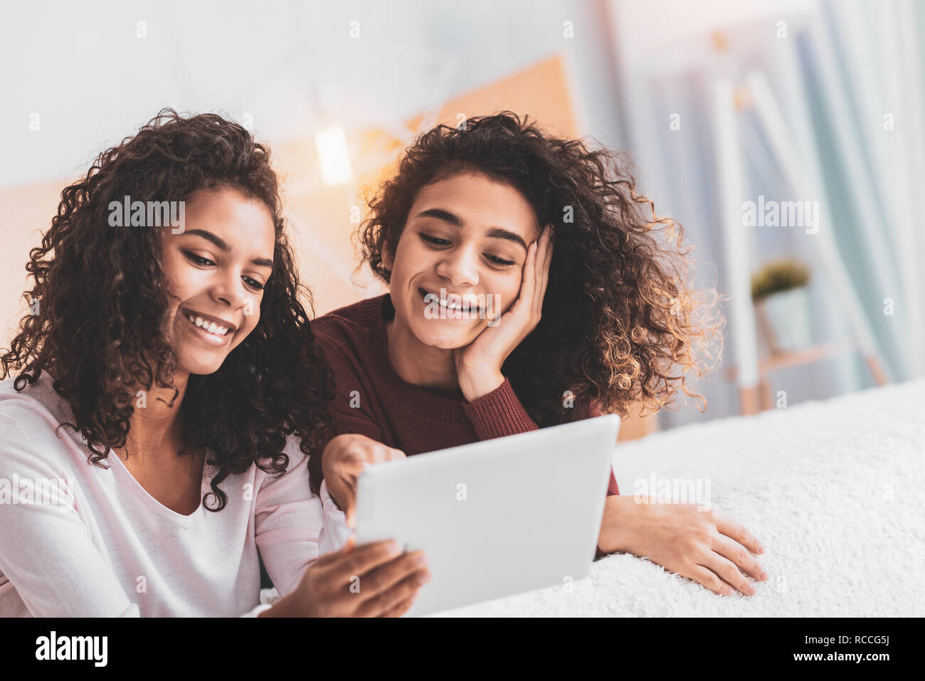 Two friends laughing watching very funny comedy Stock Photo - Alamy