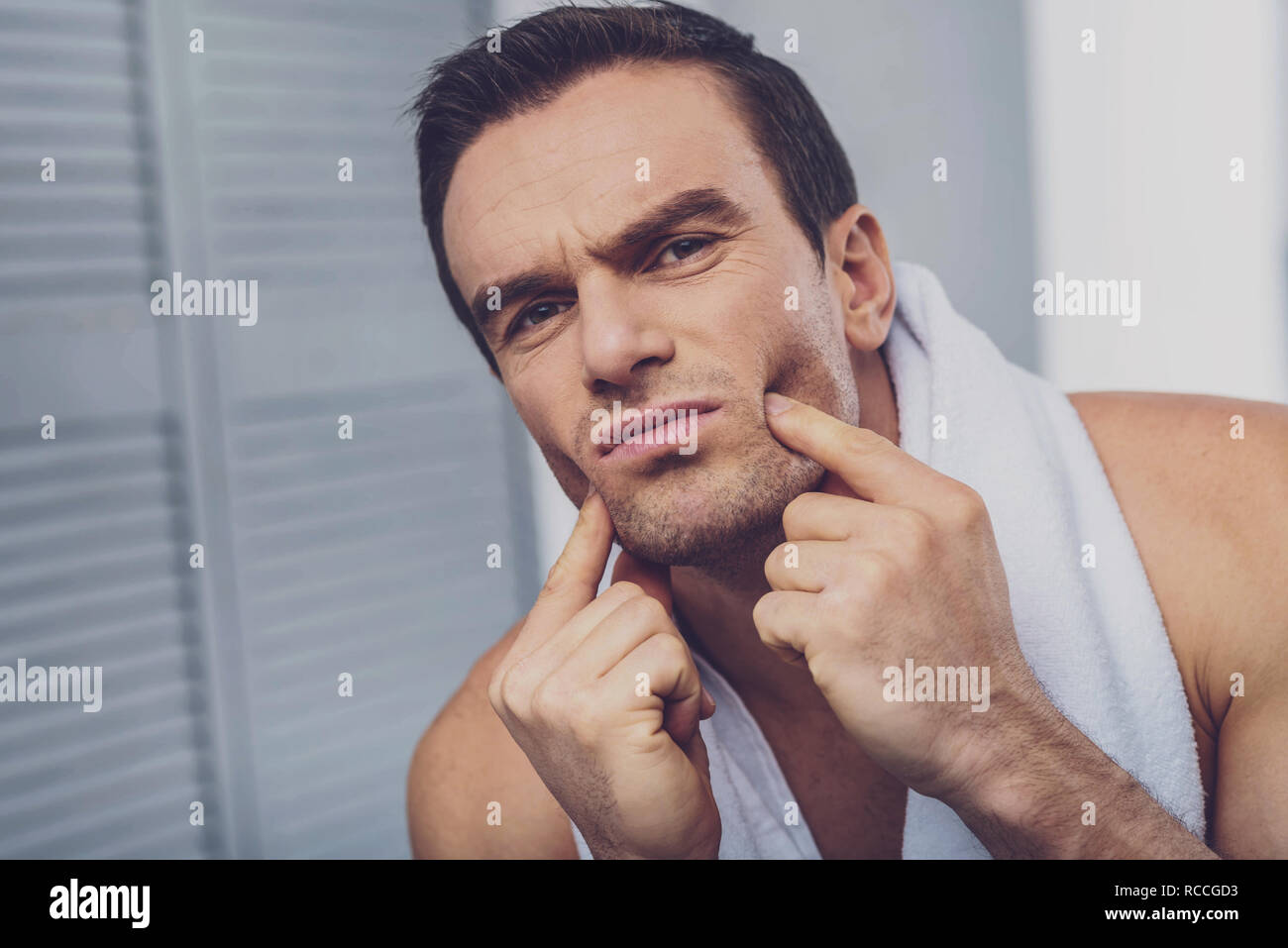 Man touching cheeks hi-res stock photography and images - Alamy