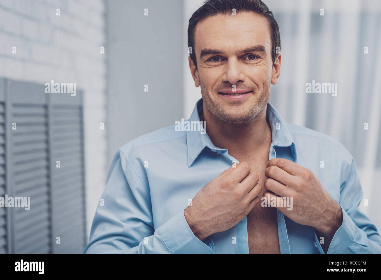 Attractive cheerful man looking at you Stock Photo - Alamy