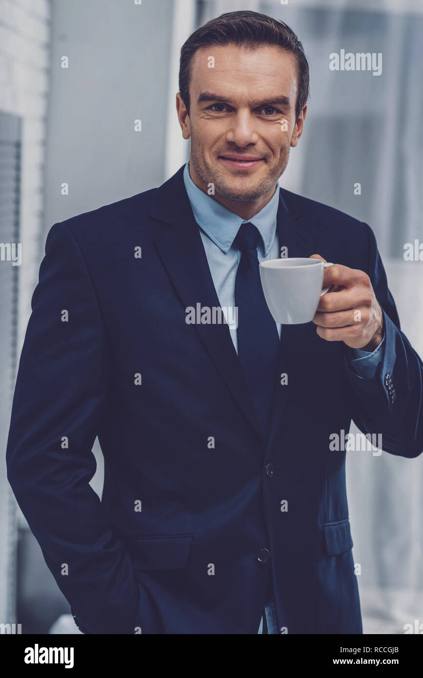 Joyful positive man having coffee Stock Photo - Alamy