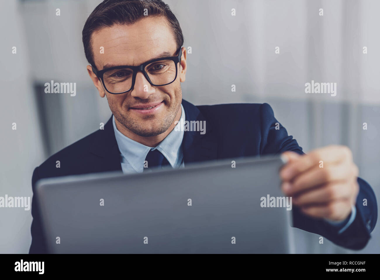 Smart confident man looking at the laptop screen Stock Photo - Alamy