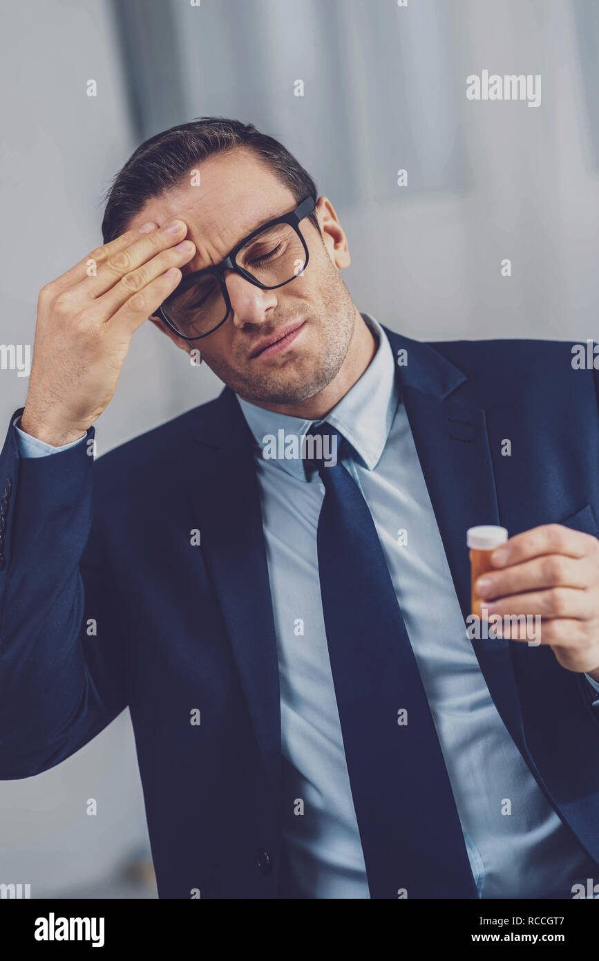 Unhappy sad man touching his forehead Stock Photo - Alamy
