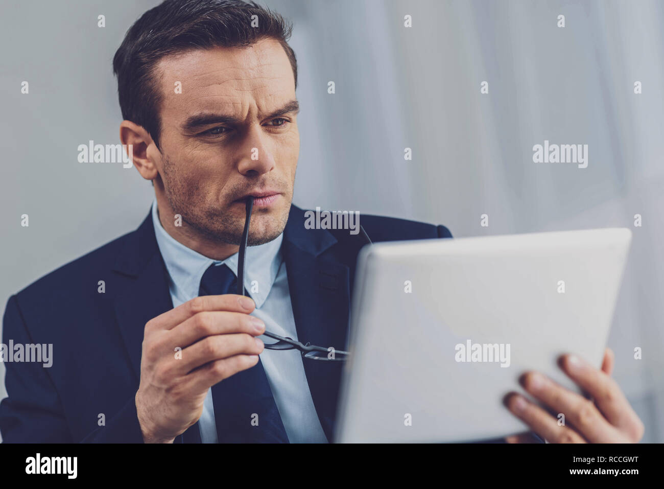 Serious handsome man working Stock Photo - Alamy