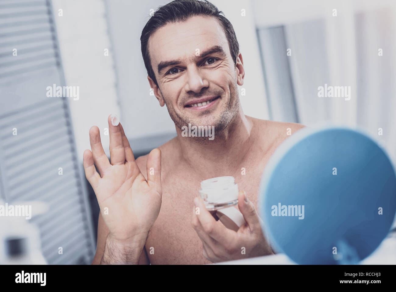 Positive delighted brunette that demonstrating cream Stock Photo - Alamy