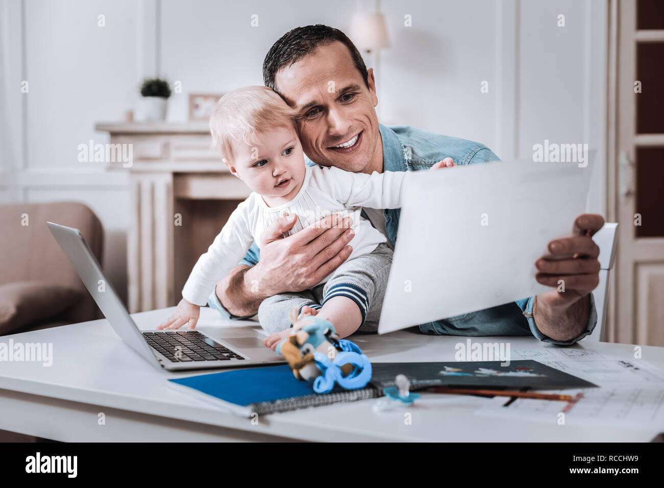 Joyful positive man working Stock Photo - Alamy