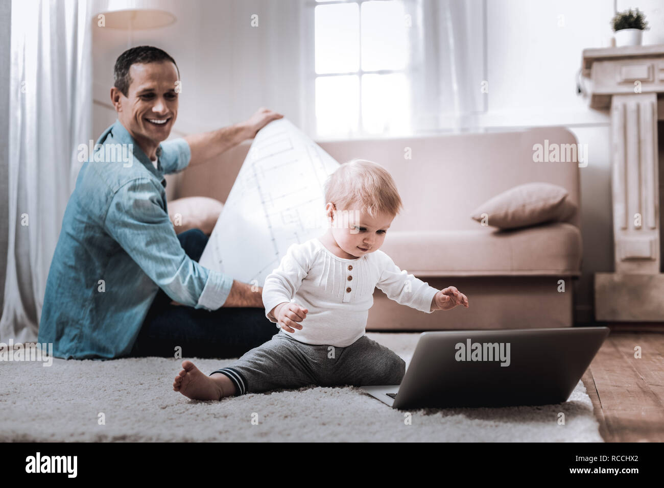 Joyful cute baby playing Stock Photo - Alamy