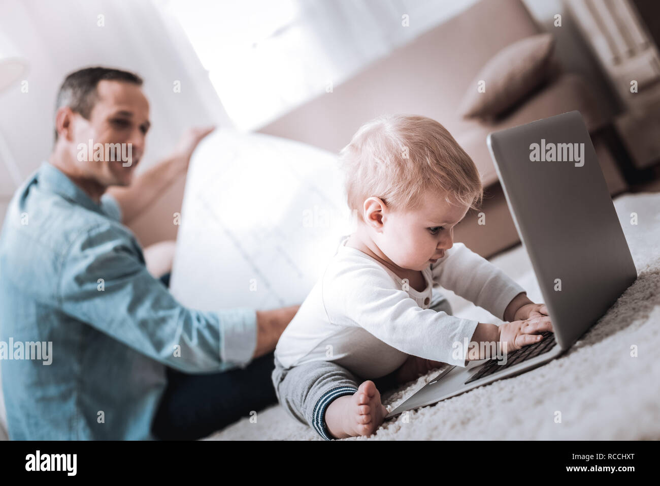 Happy cute child playing with a laptop Stock Photo - Alamy